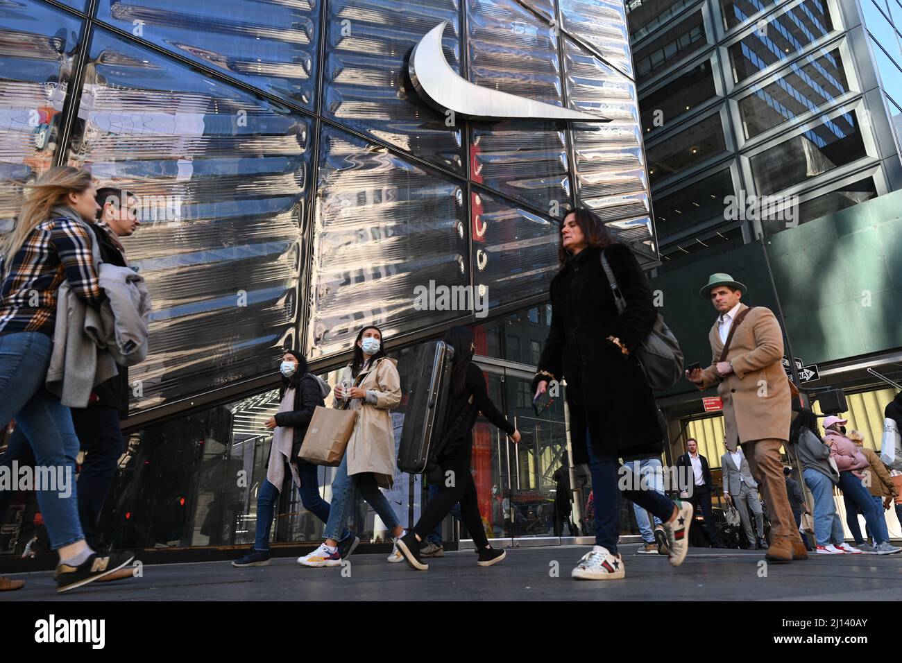 People walk past the Nike Store on Fifth Avenue in Midtown Manhattan in ...