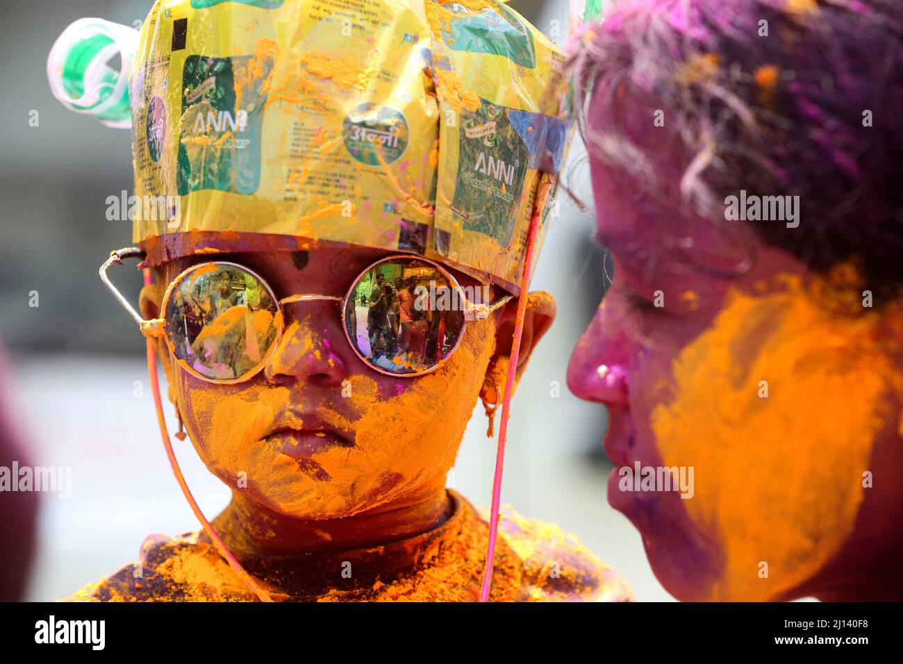 A child looks on with a colorful painted face during a procession at ...