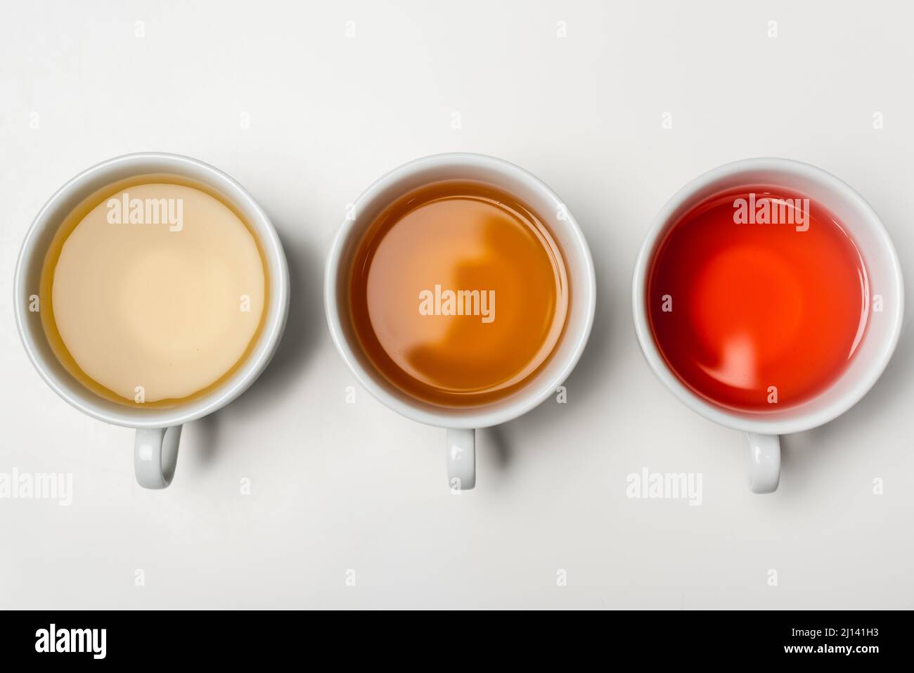 Top view of cups of tea on white background Stock Photo - Alamy