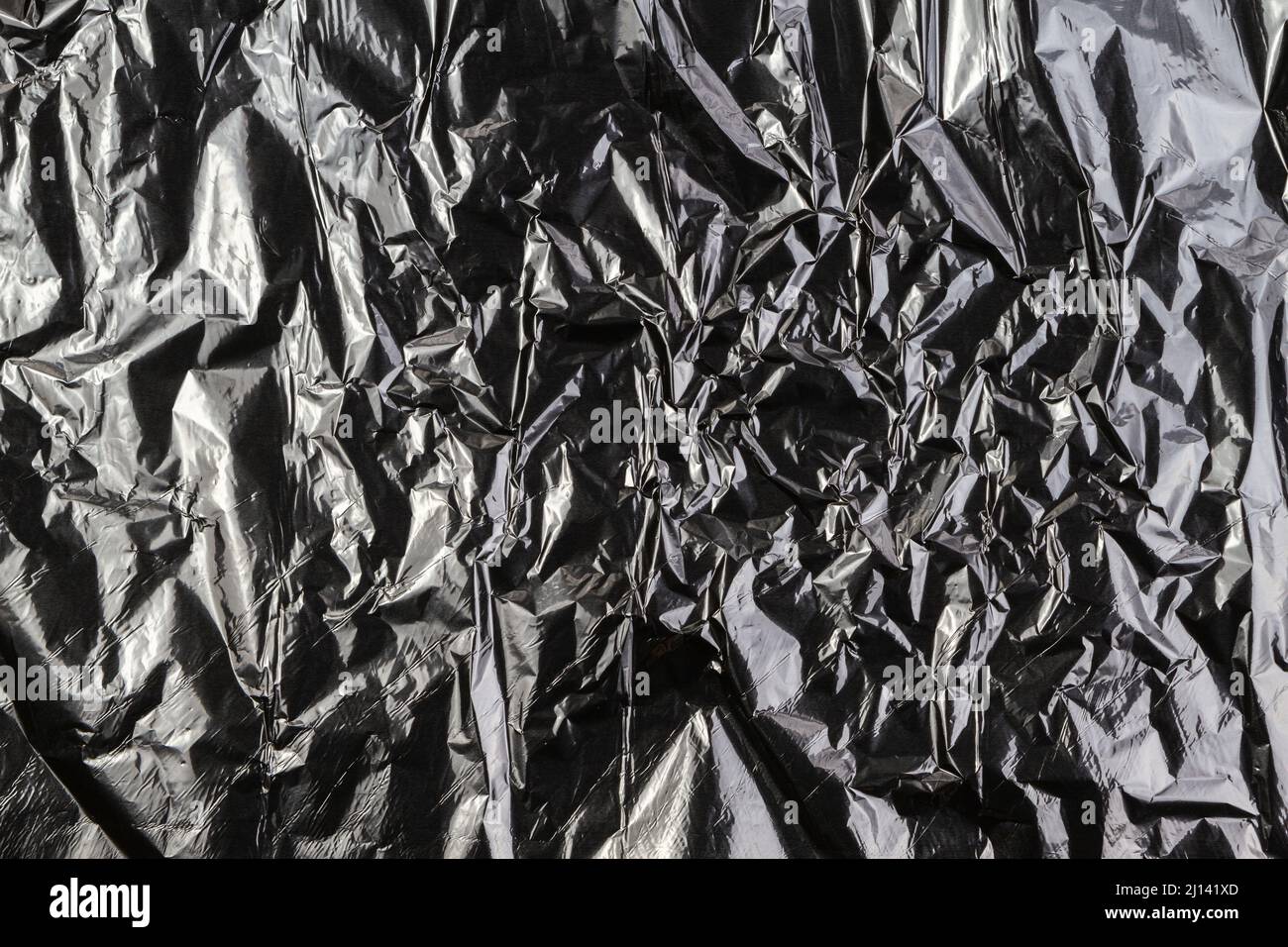 Black dark silver crumpled plastic material texture background Stock ...