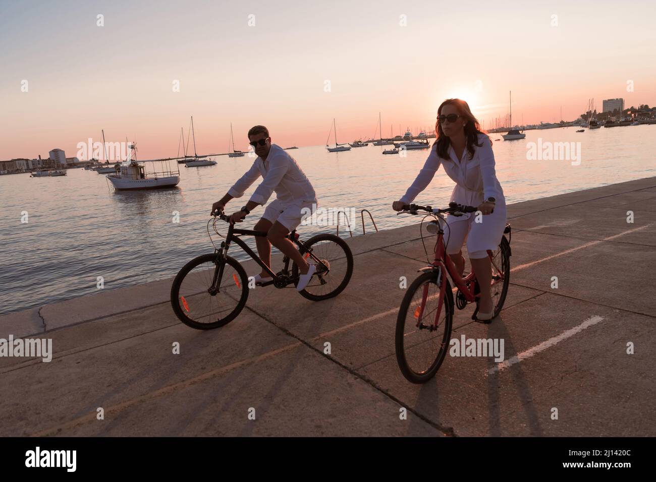 Happy family enjoying a beautiful morning by the sea together, parents ...