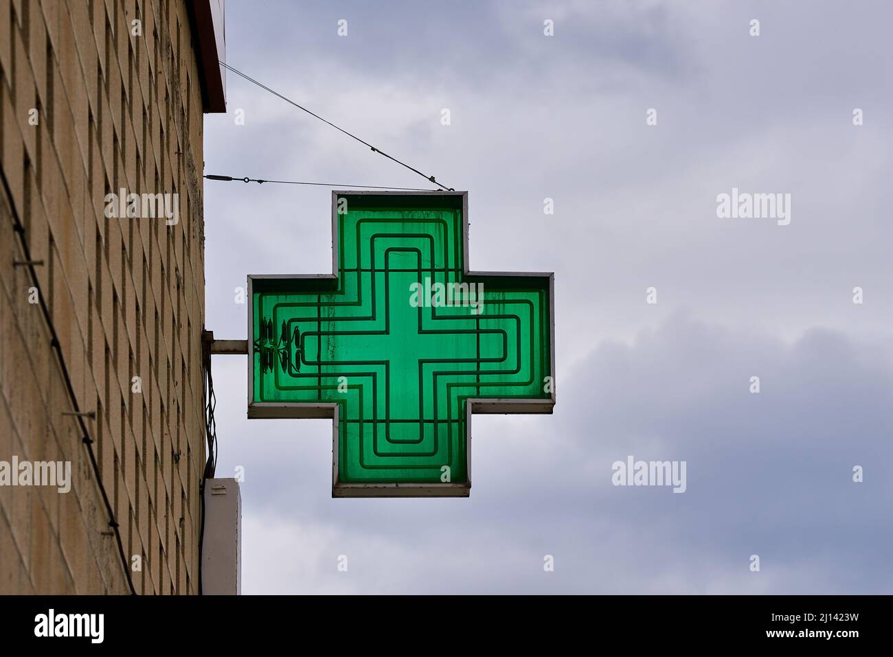 green cross-shaped pharmacy sign with sky in the background Stock Photo ...