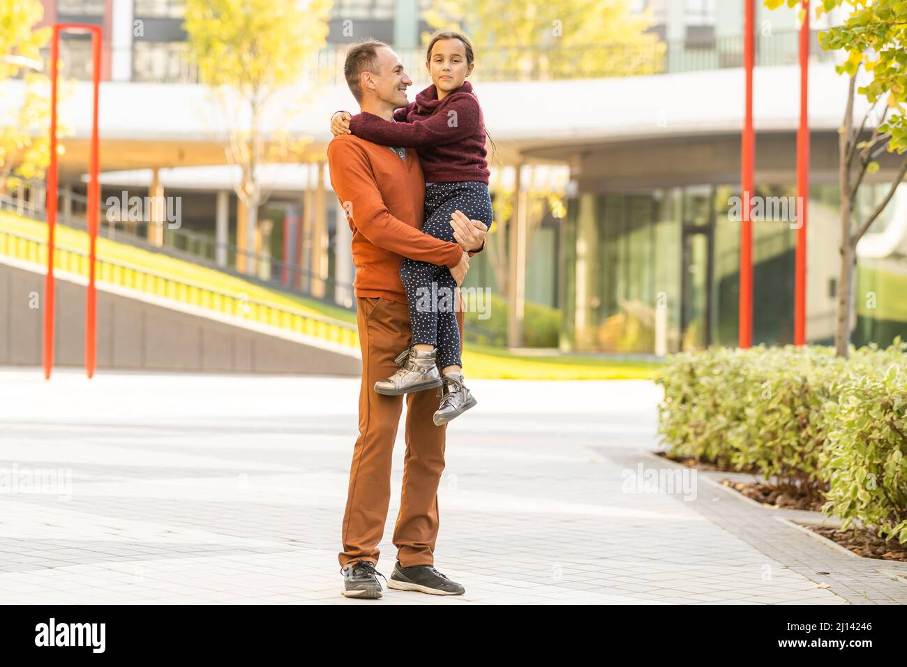Happy father and daughter walking together in park on an autumns day ...