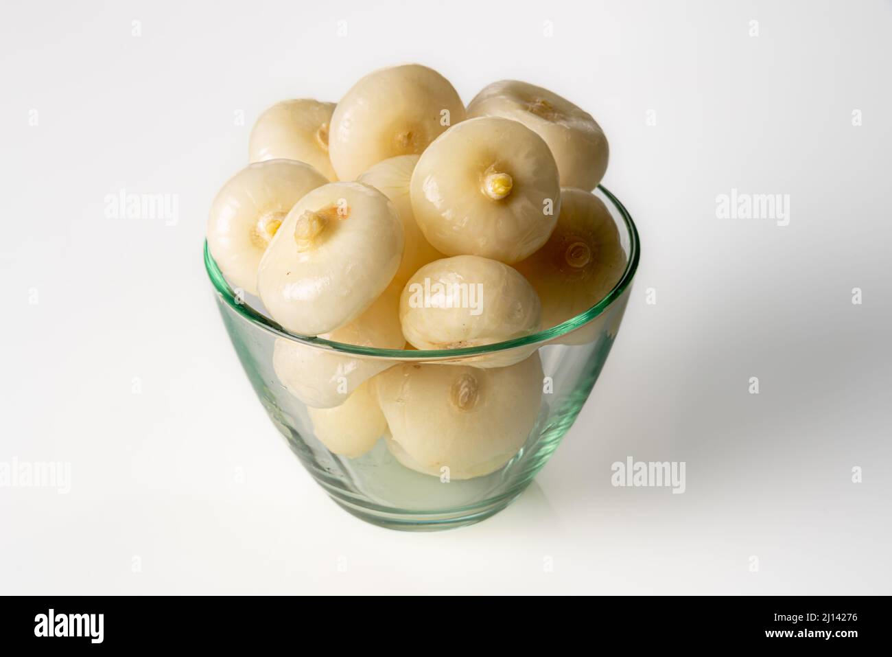 Small flat onions (in Italy called borettane onions) in glass bowl on ...