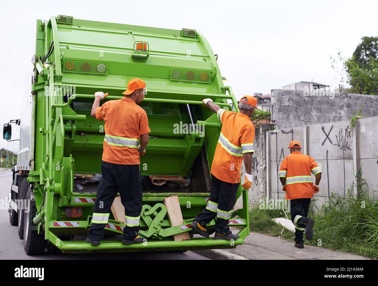 Keeping the city clean. Cropped shot of a team of garbage collectors ...
