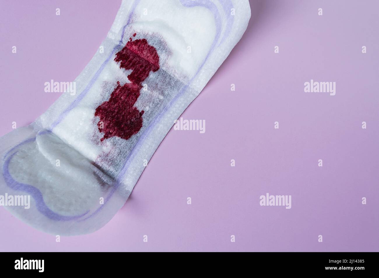 Menstrual blood on a sanitary pad on pink background. Woman hygiene ...