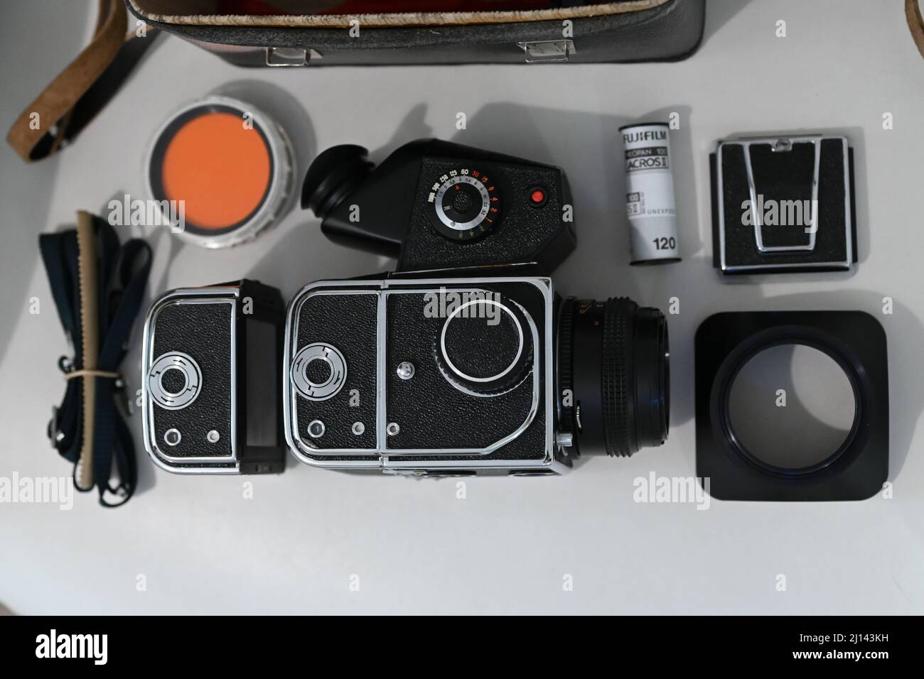 Vertical view of a vintage camera on a white surface Stock Photo - Alamy