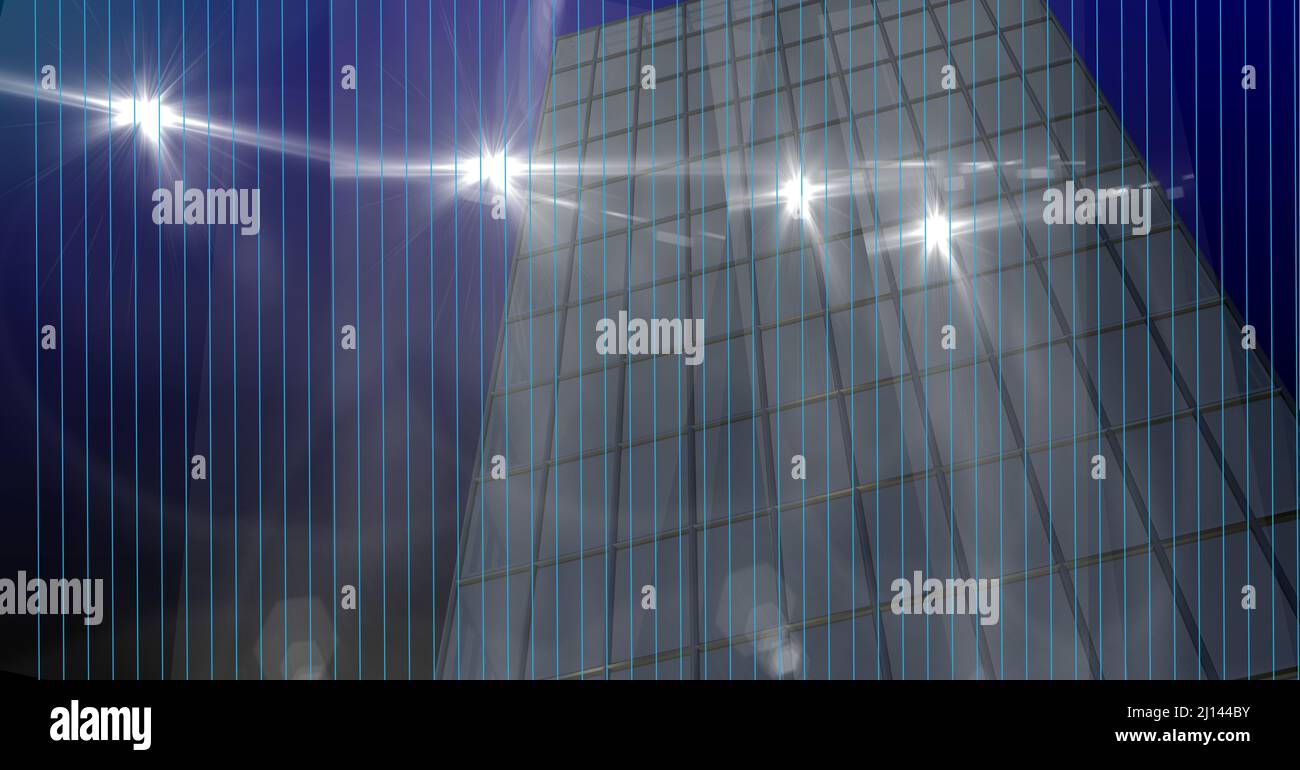 Spots of lights over tall building model against blue background Stock ...