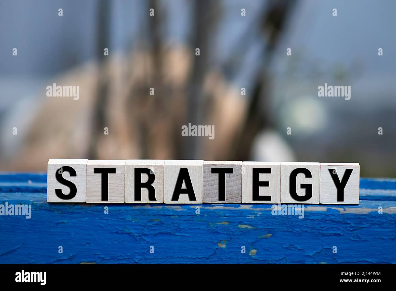 Word STRATEGY on wooden cubes on light blue background Stock Photo - Alamy