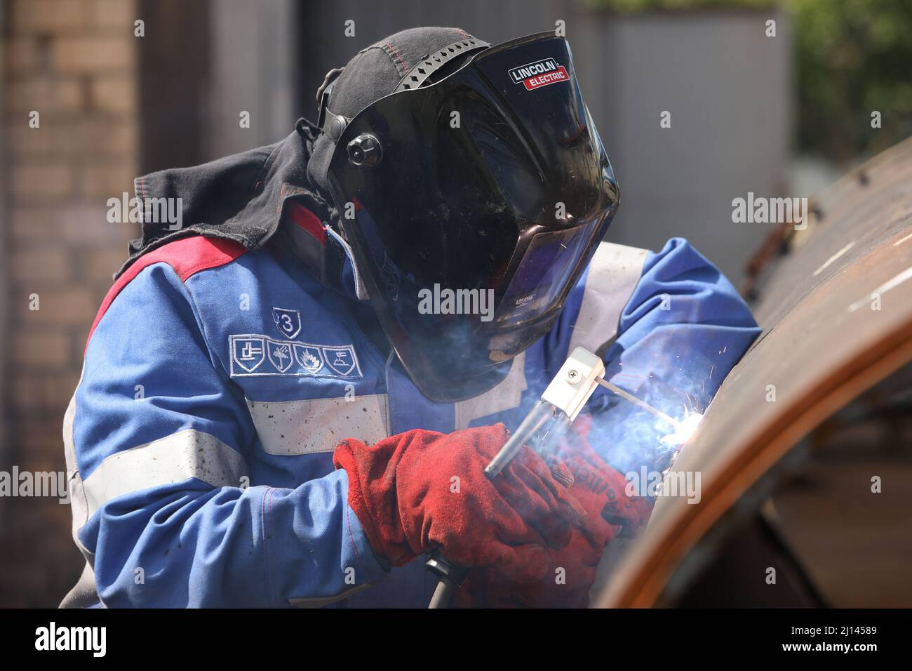 Male welder works. Welding joint of large diameter pipe. High pressure ...