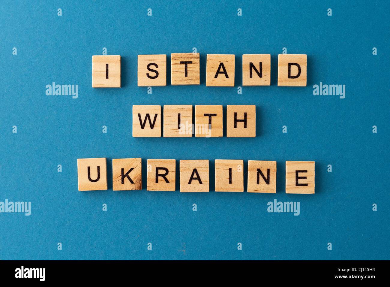I stand with Ukraine background. Phrase from wooden letters. Support ...
