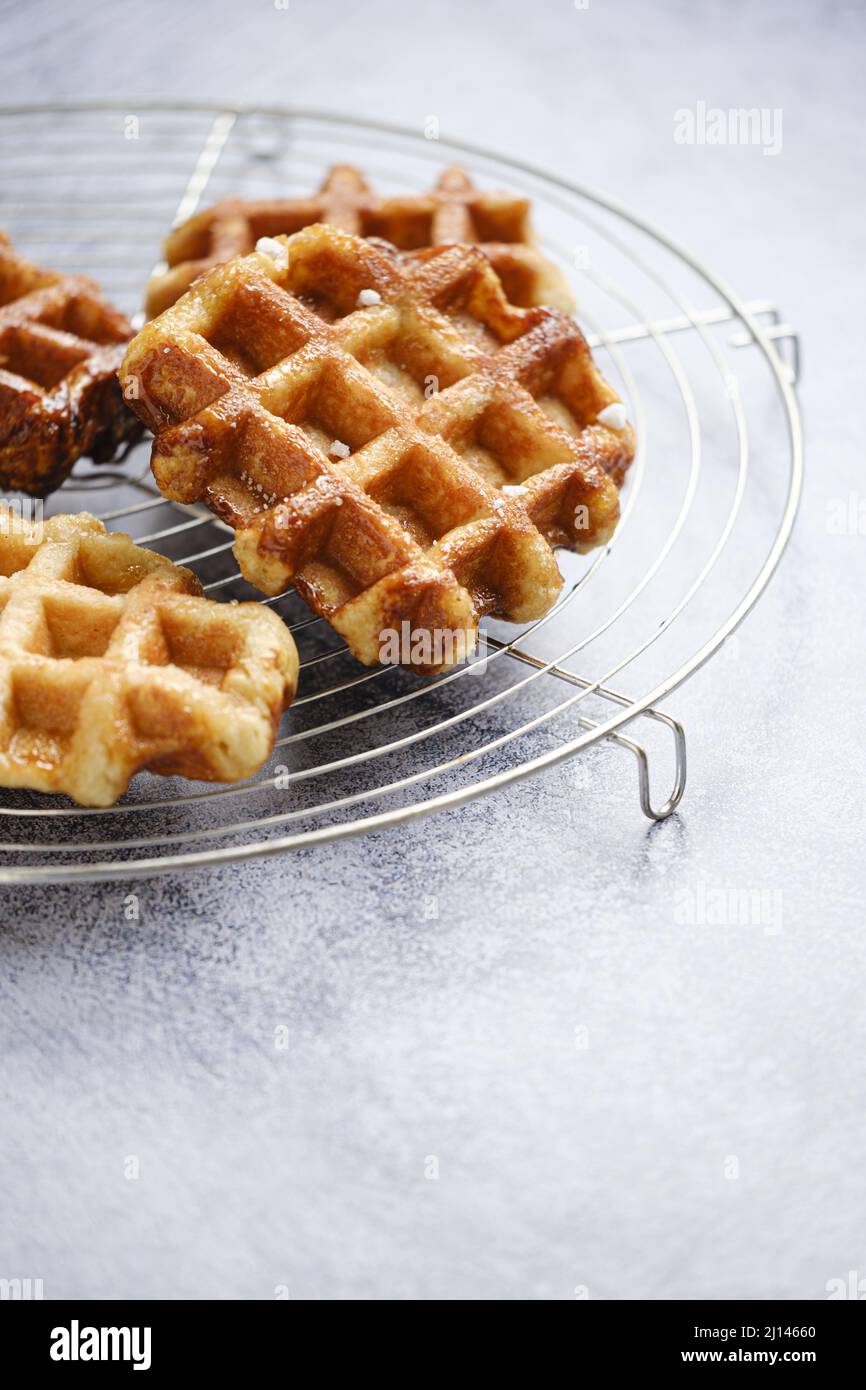 Vertical shot of Belgian waffles from the city of Liege on round steel ...