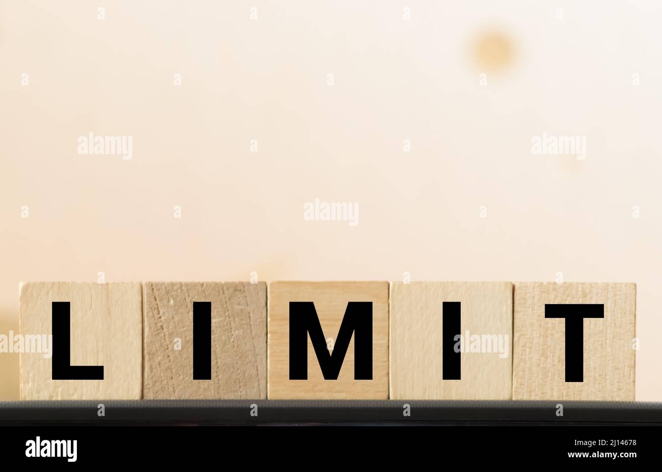 Letter block in word limited on wood background Stock Photo - Alamy