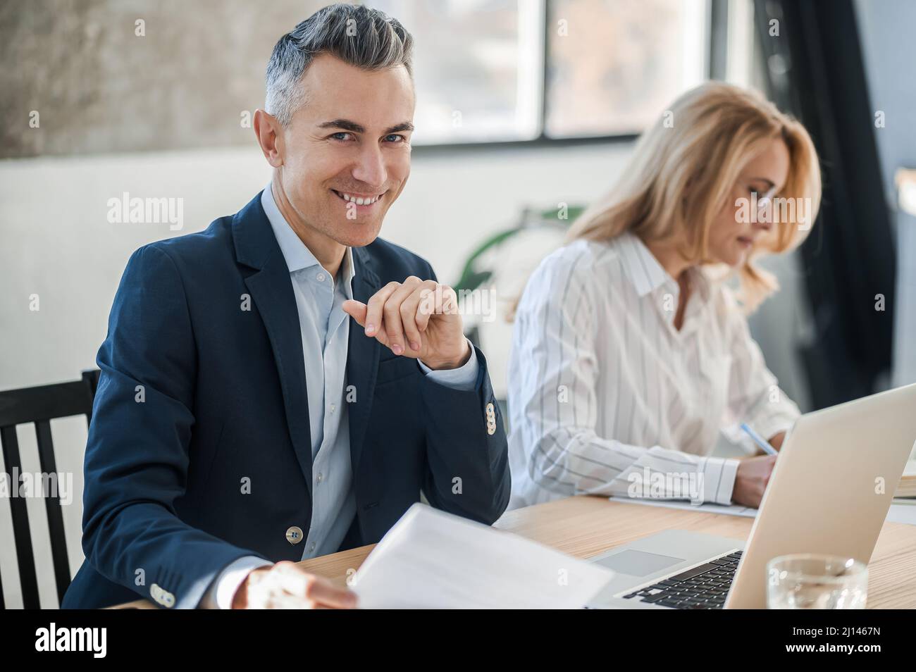 Two colleagues working together in the office Stock Photo - Alamy