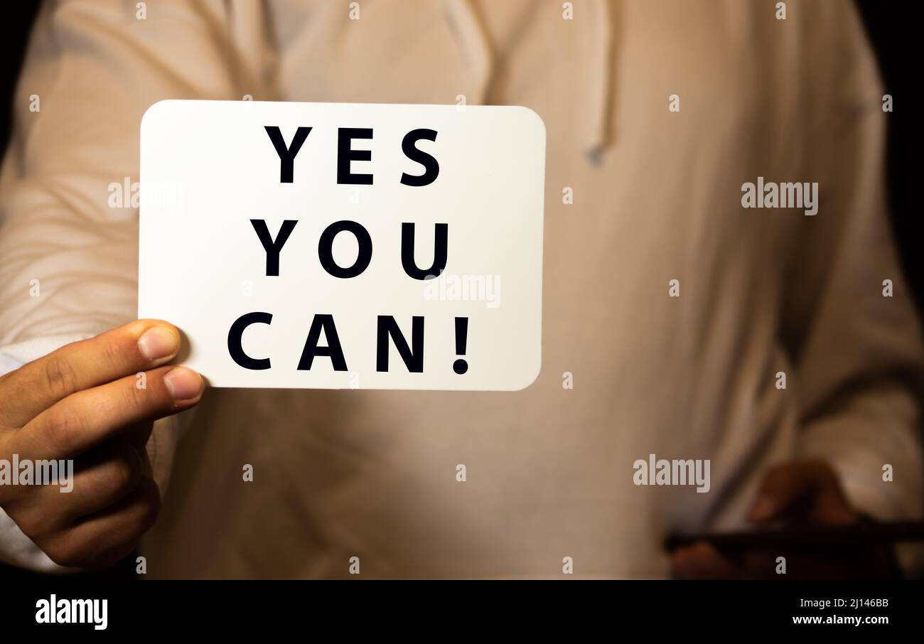 Male finger pointing at a Yes you can sign on a virtual screen Stock ...