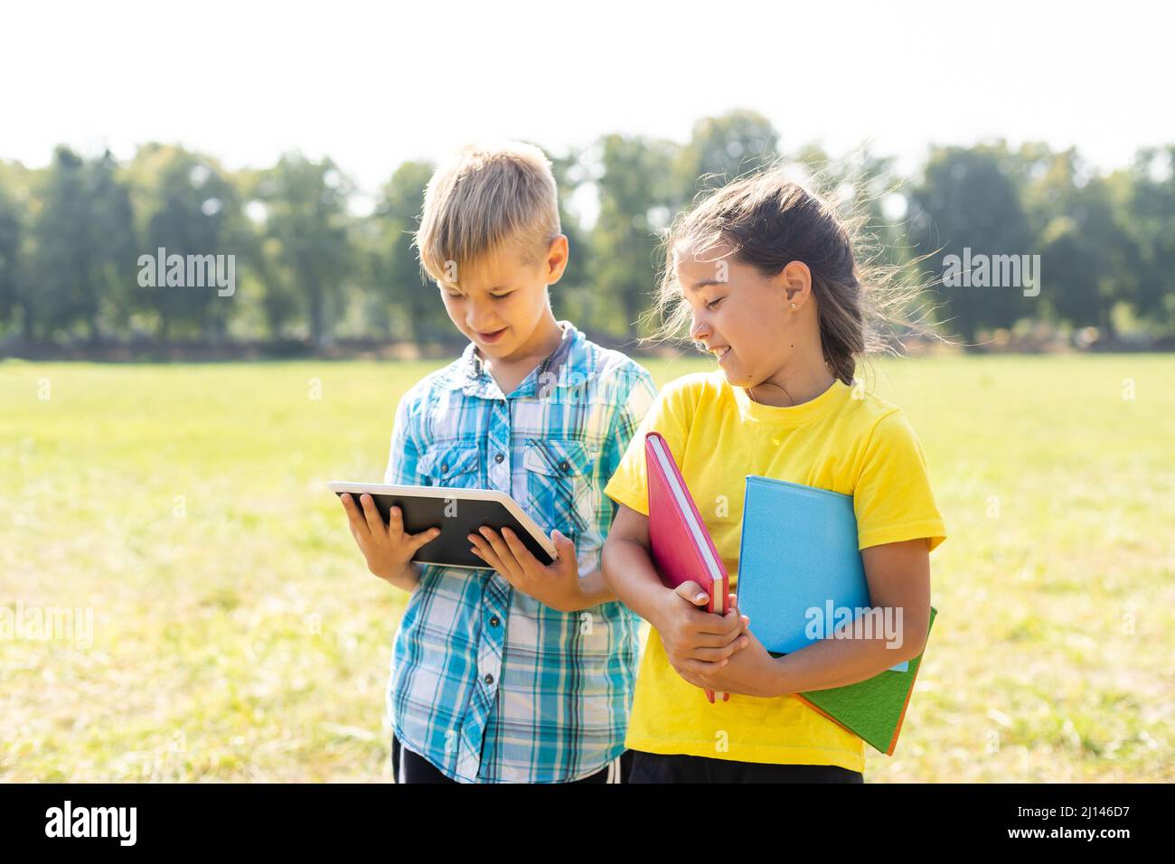 Portrait Of Excited Elementary School Pupils On Playing Field At Break ...
