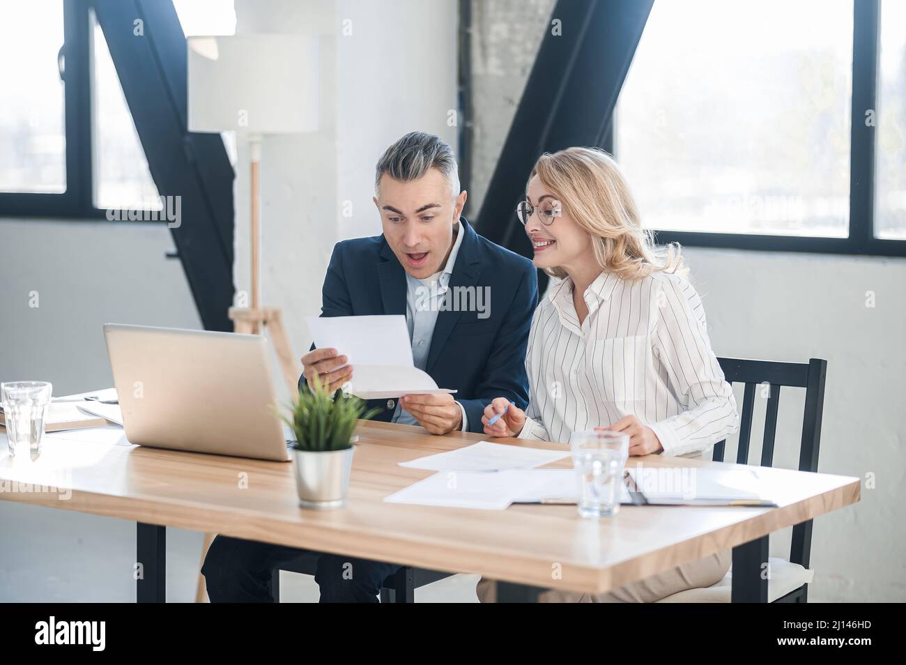 Two office people looking at papers hi-res stock photography and images ...