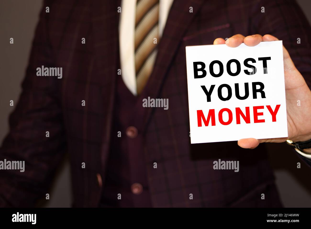 Boost Your Income. Man holding a card with a message text written on it ...