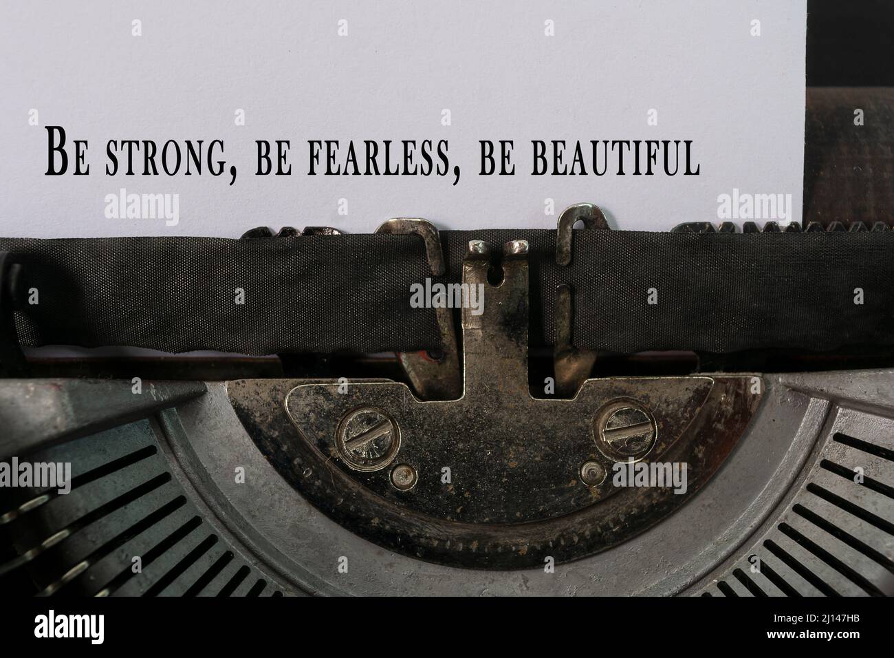 Motivational quote typed on an old classic typewriter - Be strong, be ...