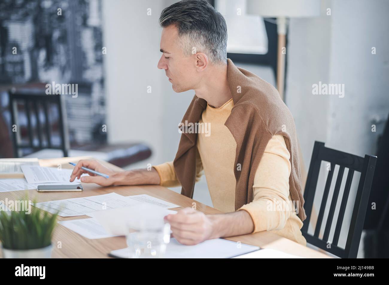 Scrutinizing documents hi-res stock photography and images - Alamy