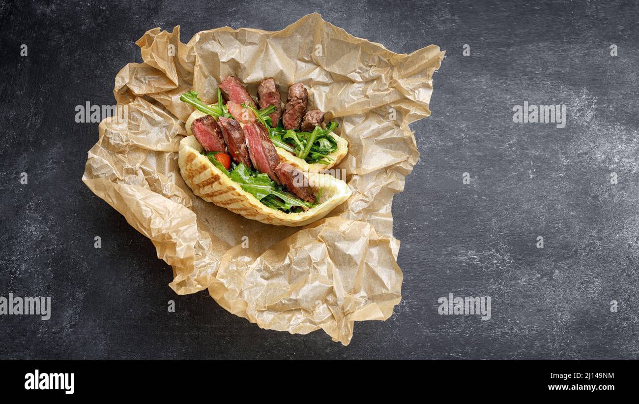 Gyros, shawarma with meat and herbs, on paper Stock Photo - Alamy