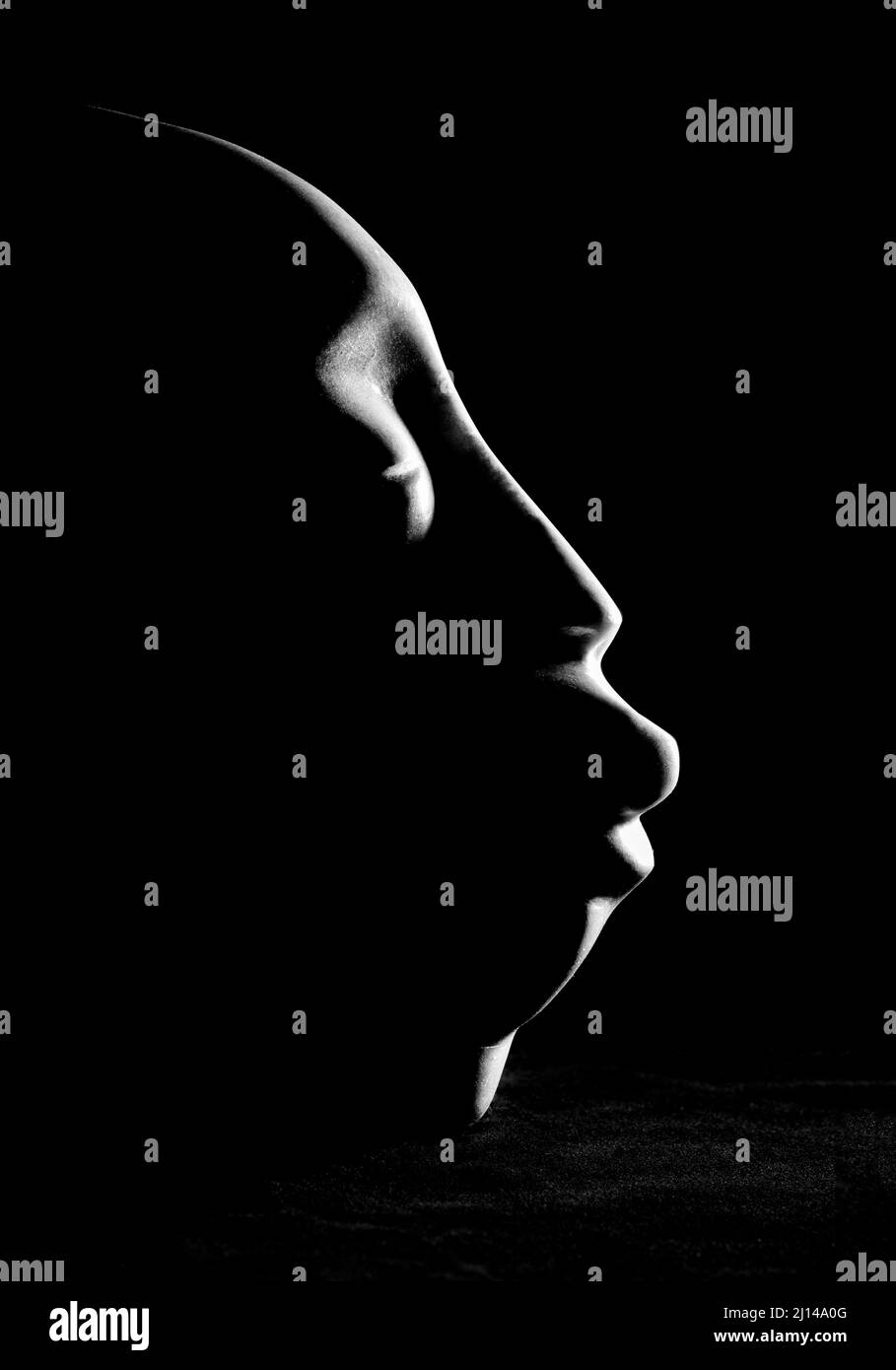 Sculpture of human face with backlighting Stock Photo - Alamy