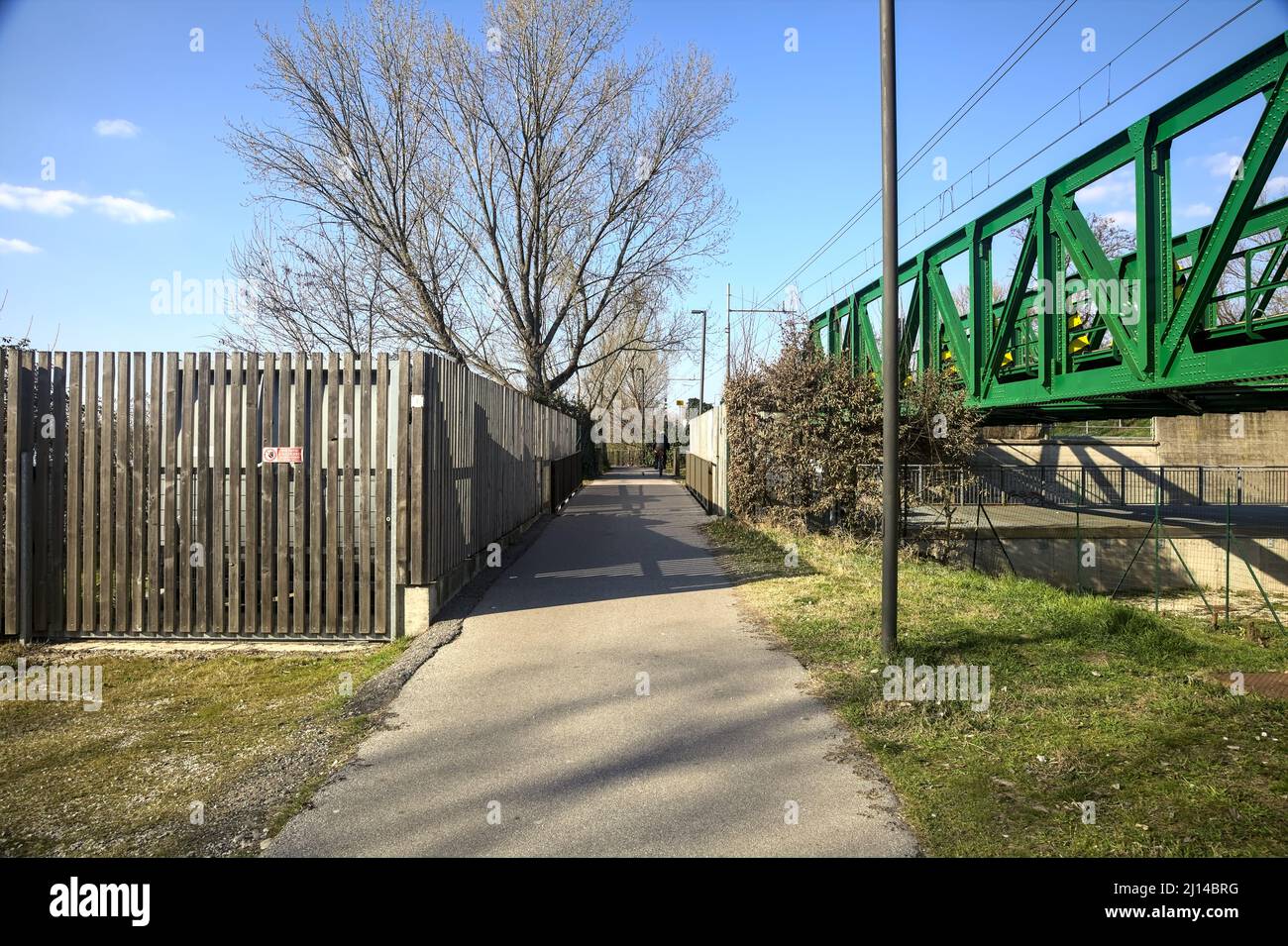 Path in a park next to a railroad bridge on a sunny day Stock Photo - Alamy