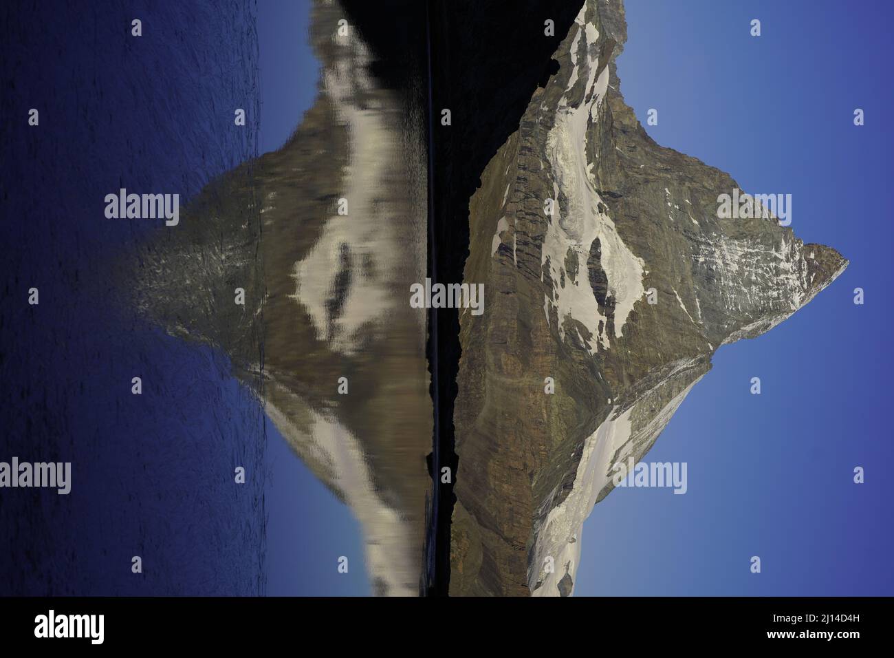 Vertical shot of the Matterhorn mountain reflecting in Rifelsee on the ...