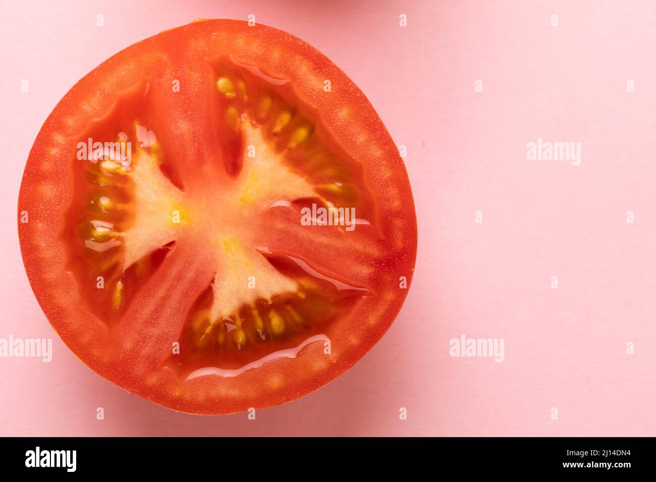 Overhead view of fresh red tomato halved cross section by copy space ...