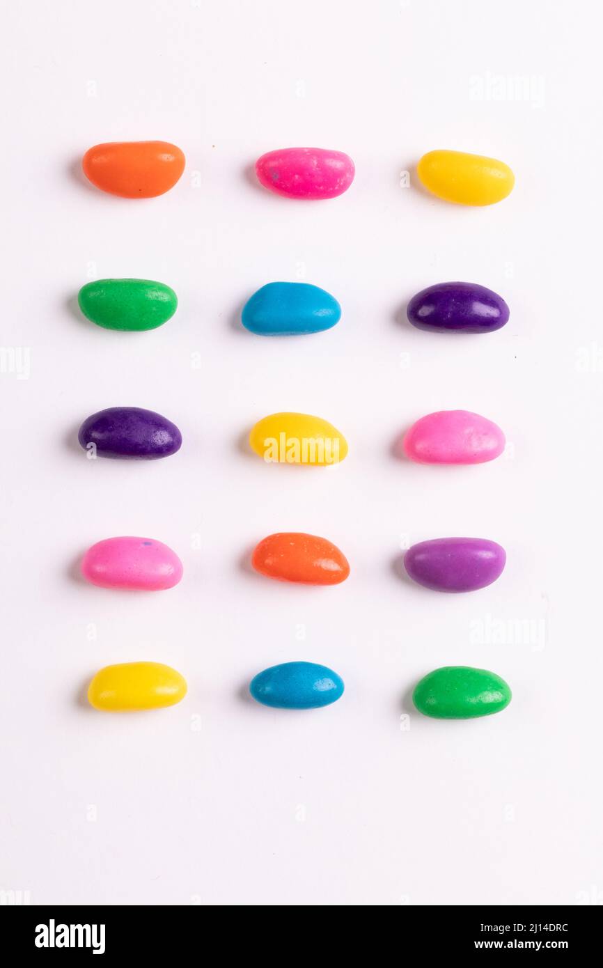 Directly above view of multi colored candies arranged in a row over ...