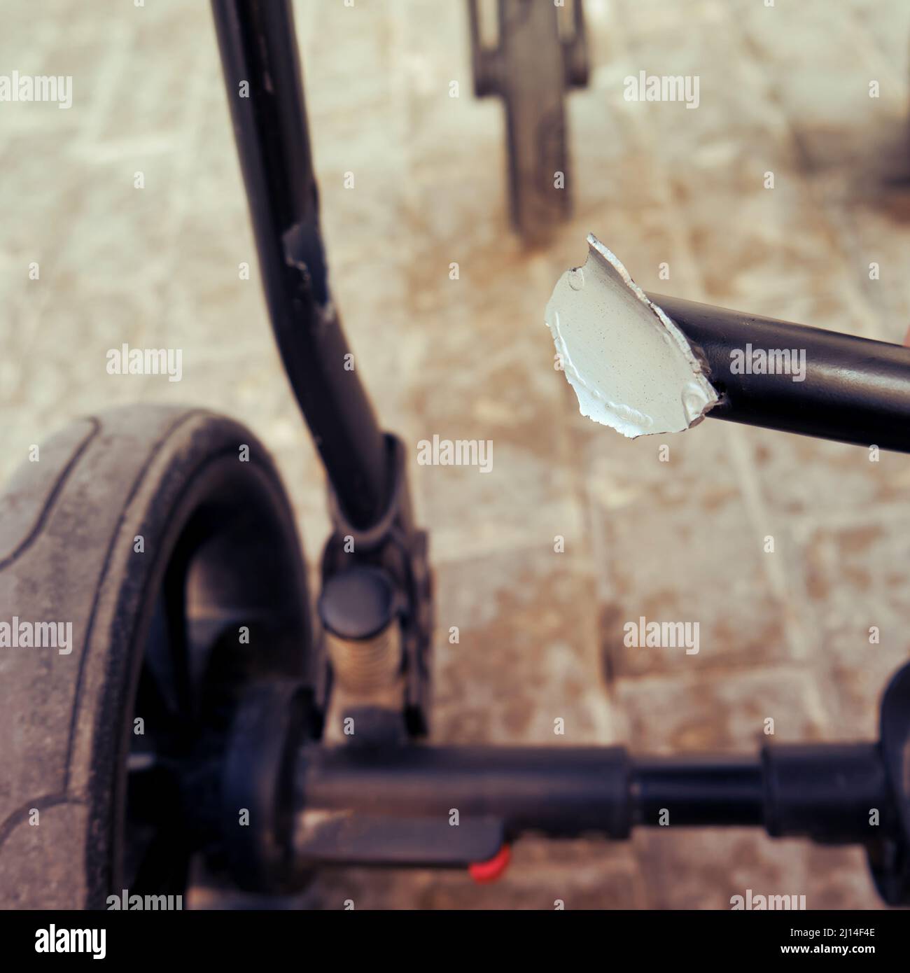 Broken chassis of a baby stroller, damage to the crossbar of the metal ...