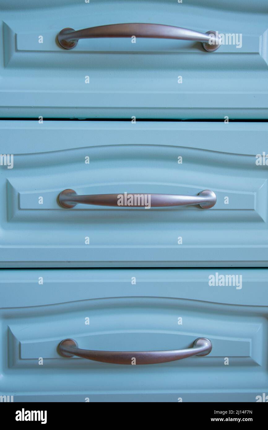 a metal shelf handles in a blue kitchen Stock Photo - Alamy