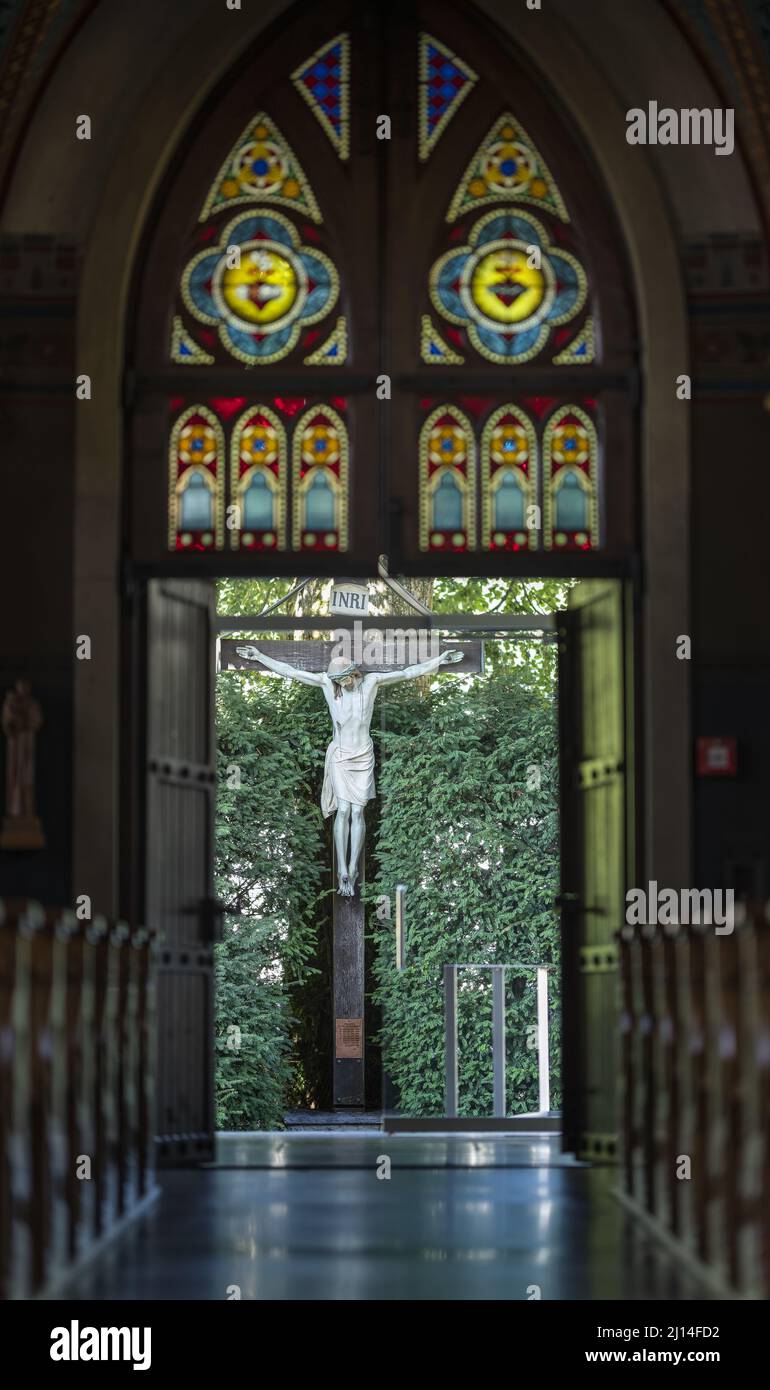 Vertical view of a Jesus Christ sculpture through the church door ...