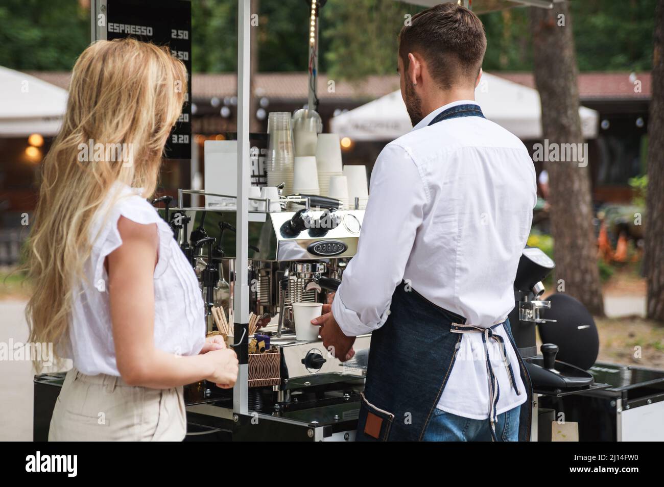 Barista man making coffee for the customer in his coffee shop Stock ...