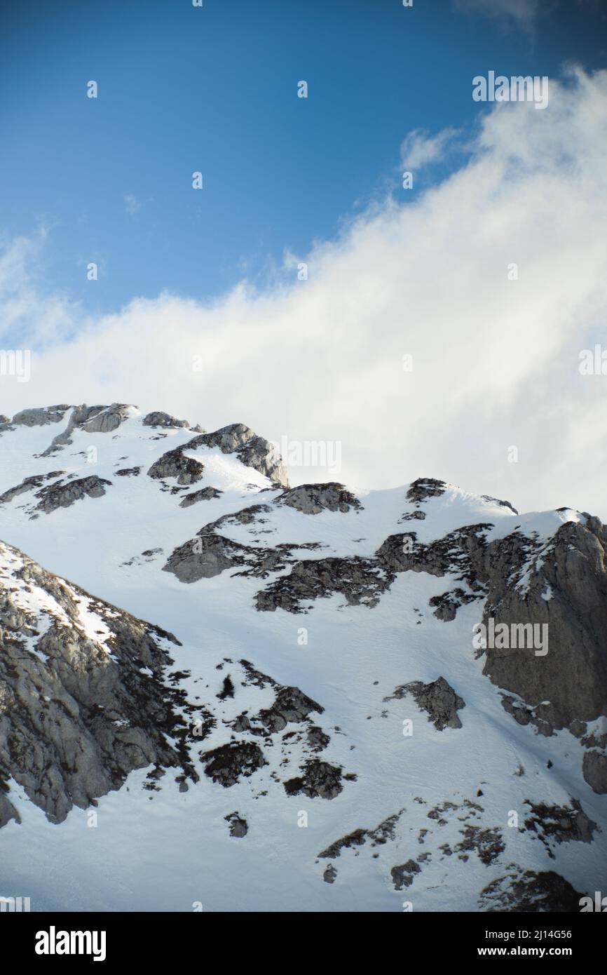 Vertical low angle shot of snowy mountain high in the winter Stock ...