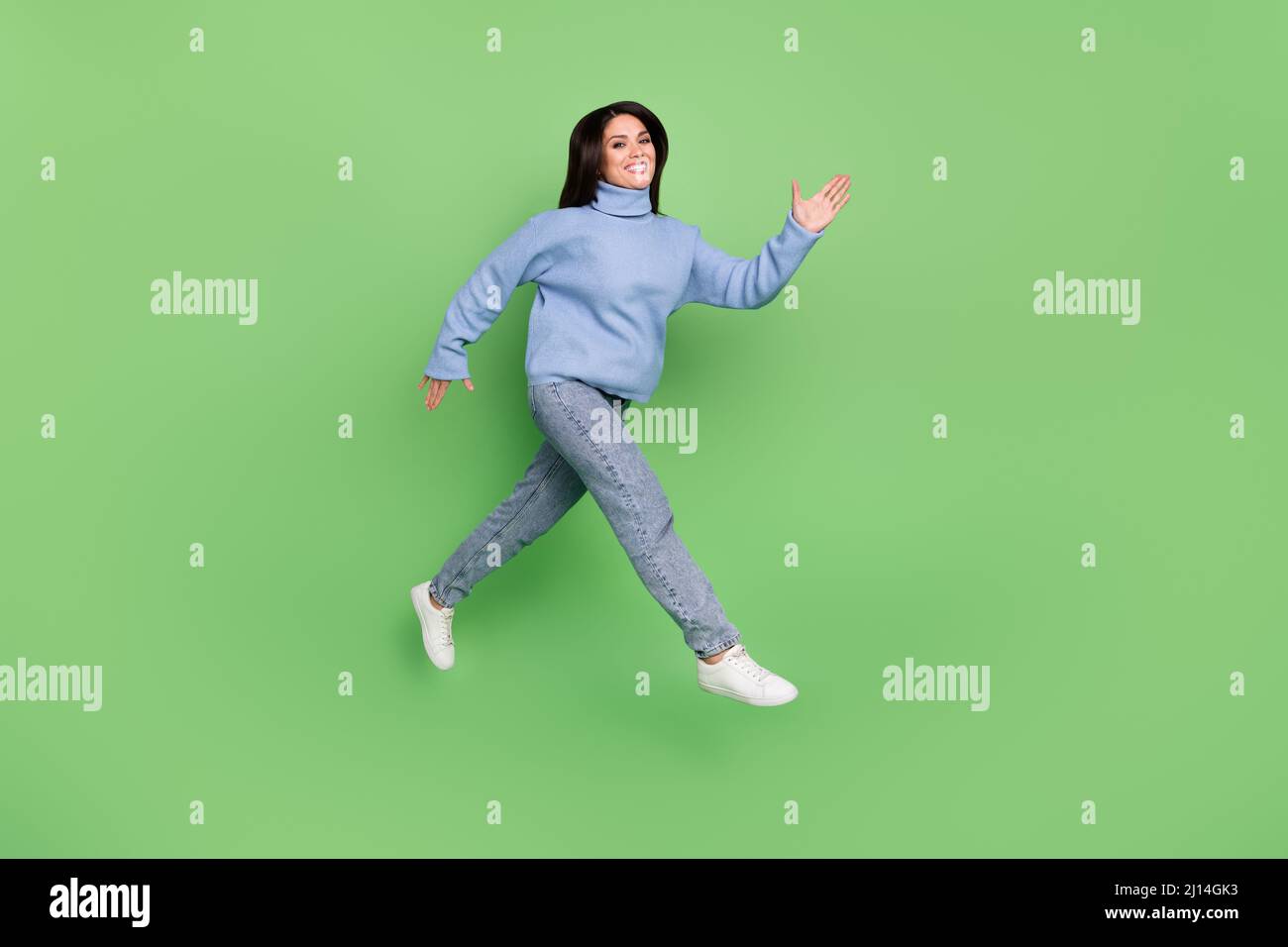 Photo of charming sweet woman wear blue pullover running fast jumping ...