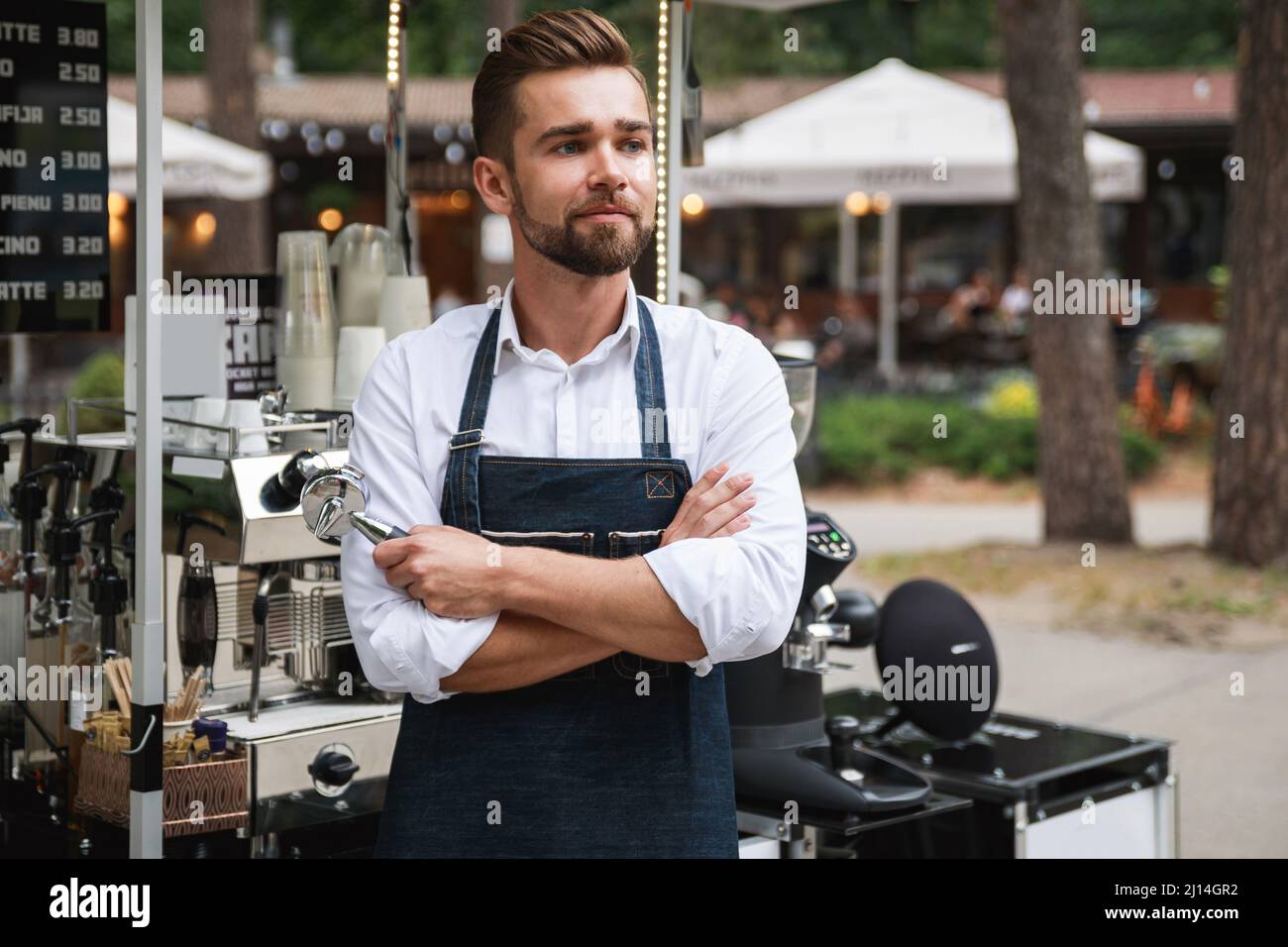 Handsome barista man during work in his street coffee shop Stock Photo ...