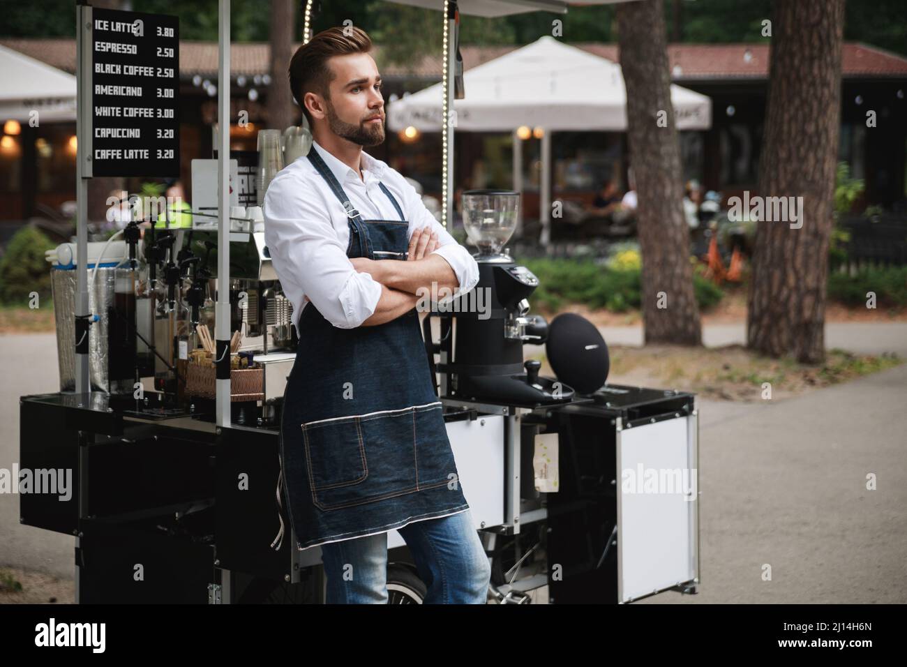 Handsome barista man during work in his street coffee shop Stock Photo ...