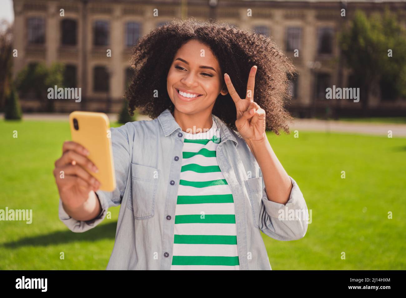 Photo of young cheerful african girl take picture cellphone show ...
