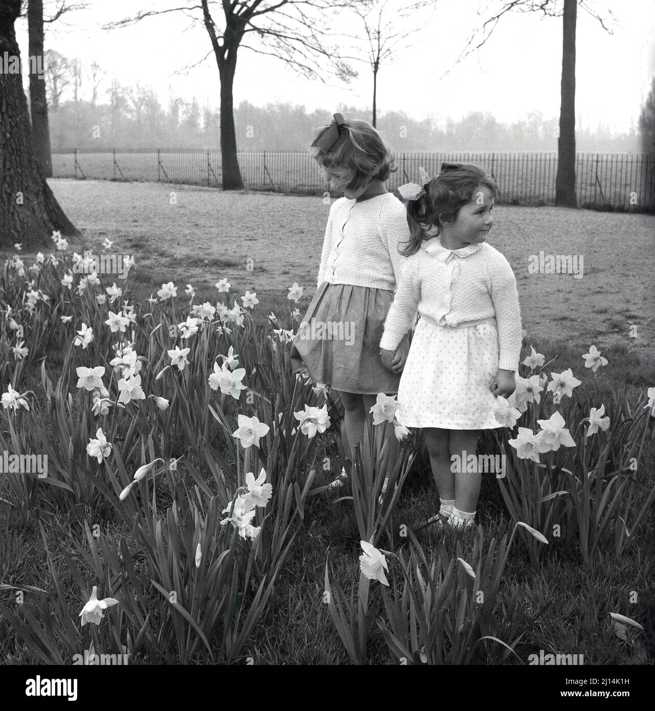 1960s, historical, springtime and two little girls, sisters holding ...