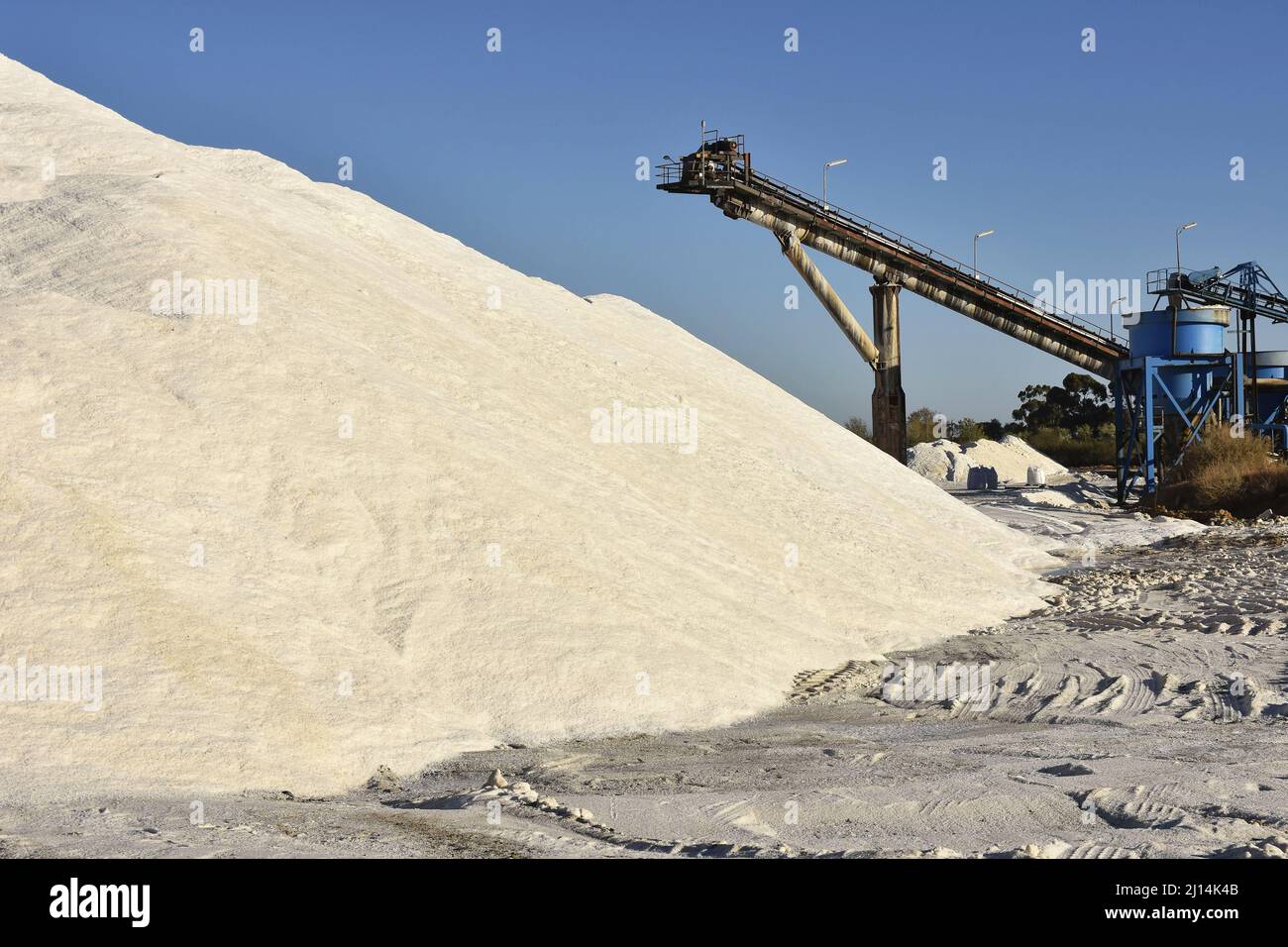 Salt production site - conveyor belt, salt is being heaped up after ...