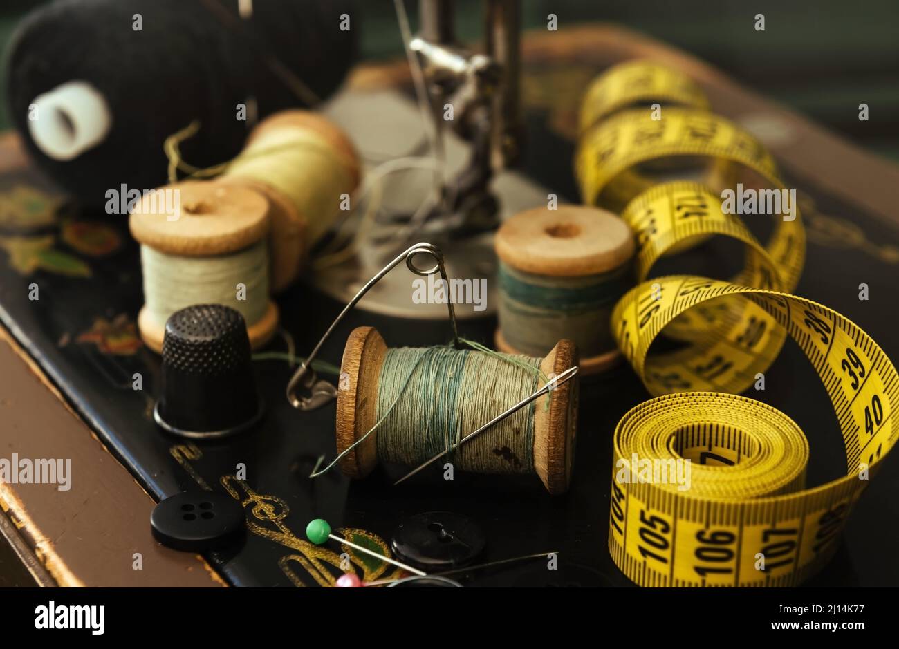 Old retro tailor's tools for sewing clothes. Centimeter, scissors ...