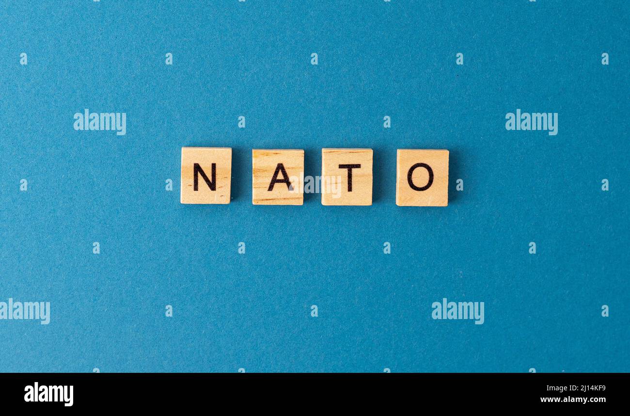 NATO background. Phrase from wooden letters. Top view words. The ...
