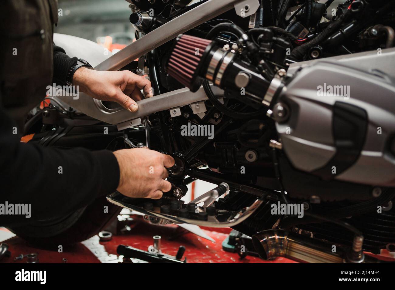 Repairman repair motorcycle, maintenance in garage. Mechanic fixing ...