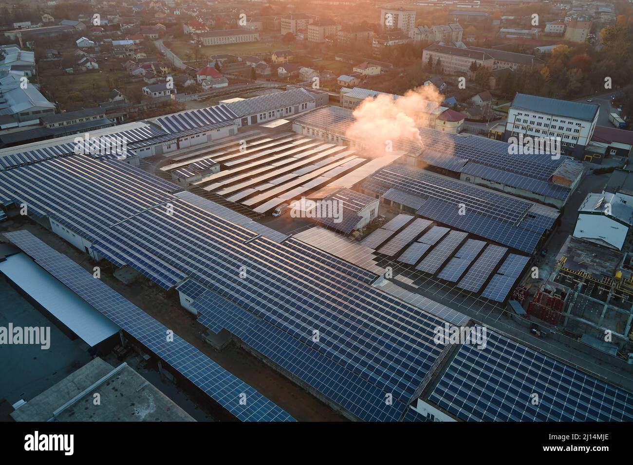 Aerial view of blue photovoltaic solar panels mounted on industrial ...