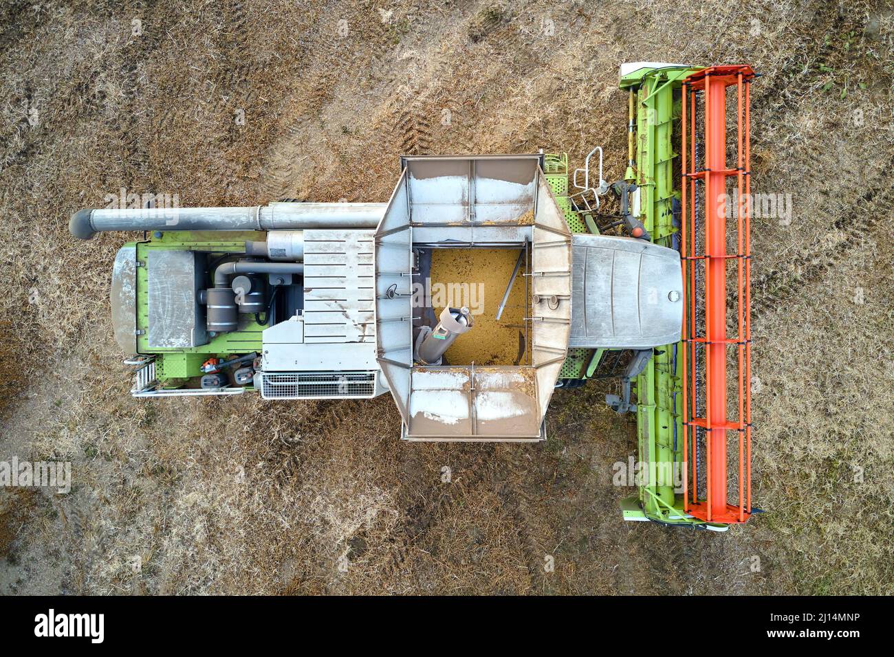Aerial view of combine harvester working during harvesting season on ...