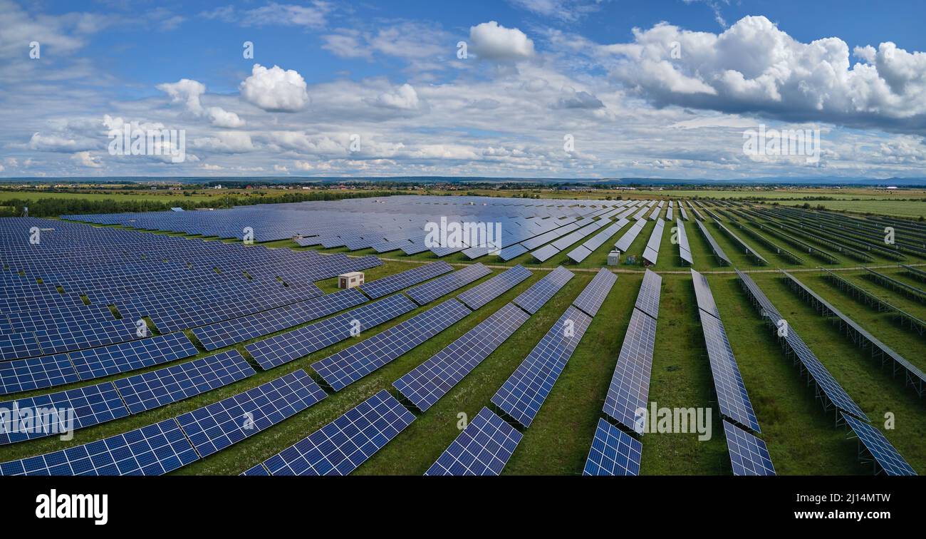Aerial view of large sustainable electrical power plant with rows of solar photovoltaic panels ...