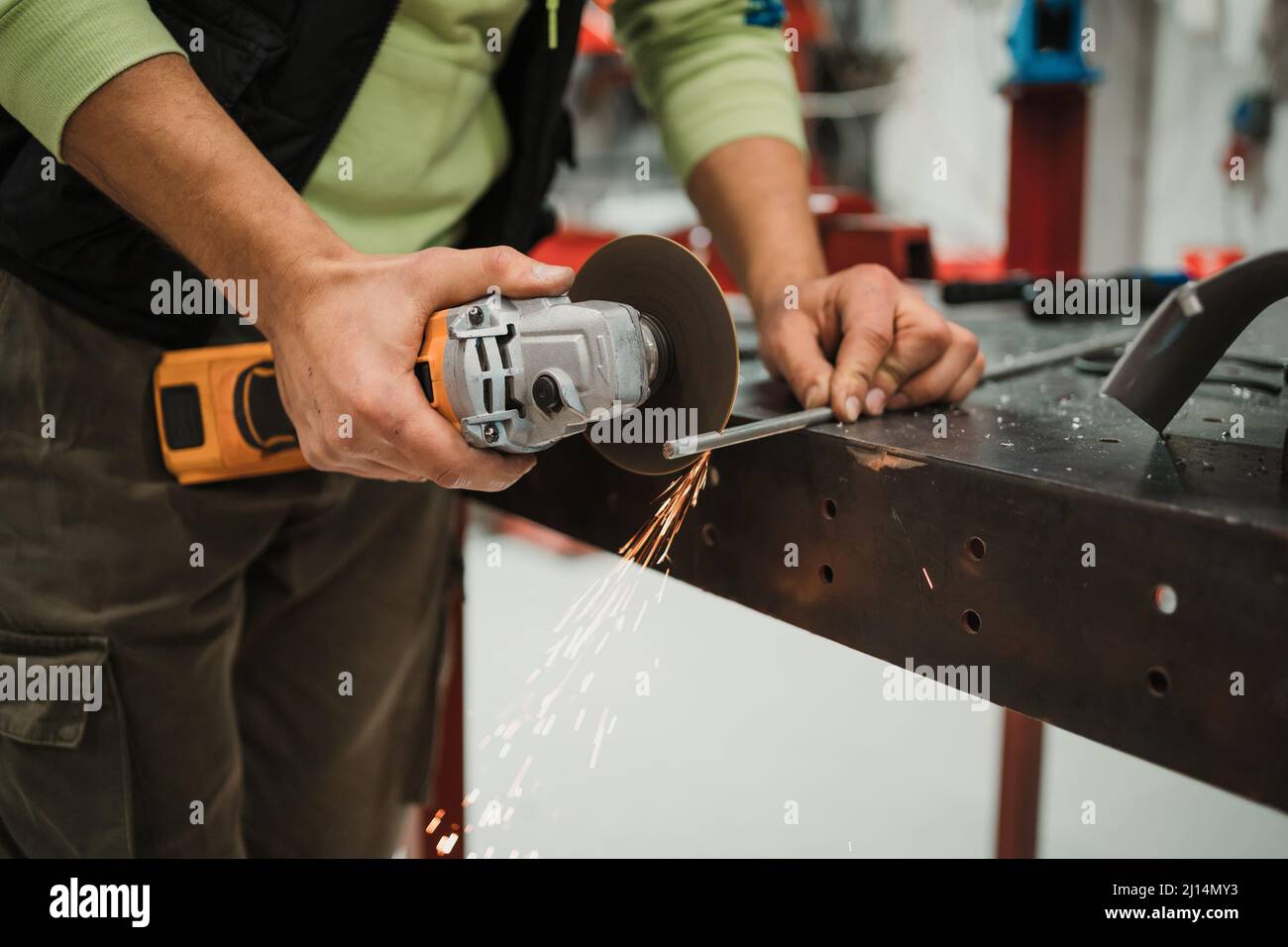 Technician worker cutting metal with many sharp sparks. Using ...