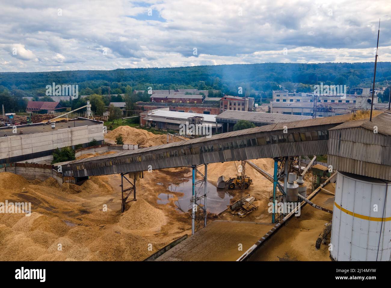 Aerial view of wood processing plant with smokestack from production ...