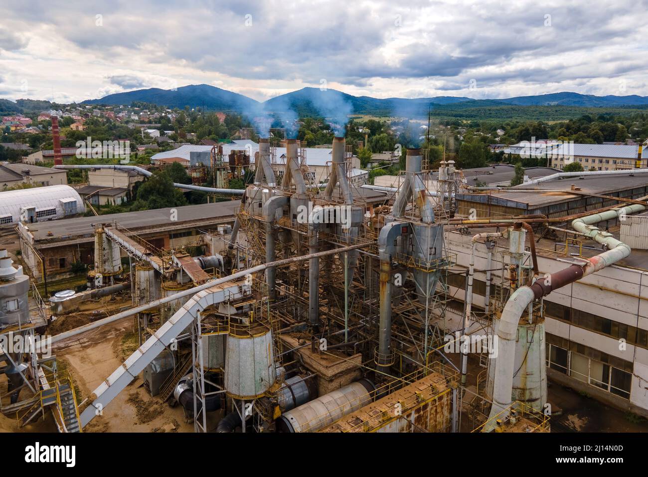 Aerial view of wood processing plant with smokestack from production ...